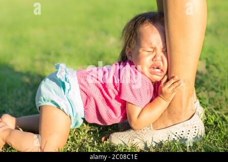 a kid grabbing mother's legs Stock Photo - Alamy