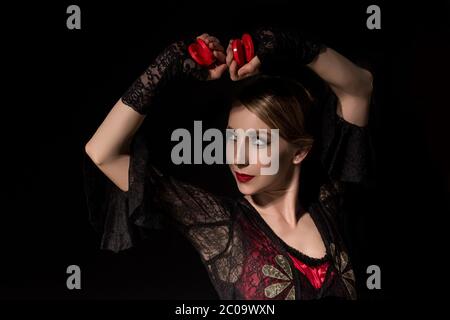 Spanish Flamenco dancer holding castanets while dancing in Seville ...