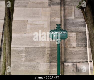 A direction sign in a cemetery, which gives the direction of a ...