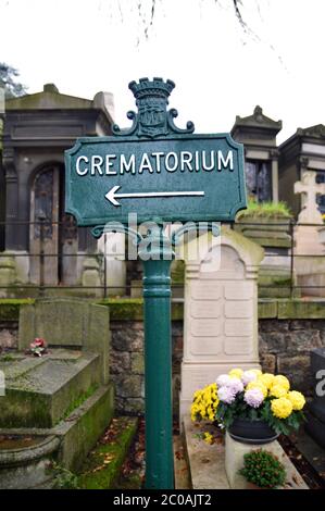 A direction sign in a cemetery, which gives the direction of a ...