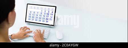 Woman Looking At Calendar On Laptop Computer Stock Photo - Alamy
