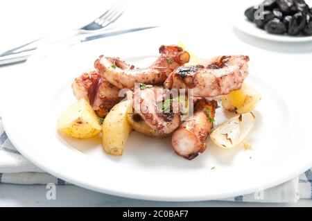 Polpo alla lagareiro a typical Portuguese dish with potatoes and onions ...