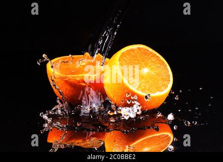 Water a stream flows on orange halves, dynamics of a liquid Stock Photo ...
