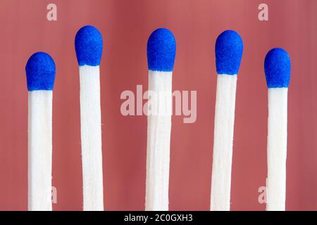 Match sticks with blue heads Stock Photo - Alamy