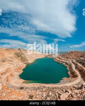 Emerald green lake in flooded opencast mine, open pit. Oval lake in ...