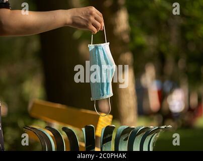Girl throwing out medical mask Stock Photo - Alamy