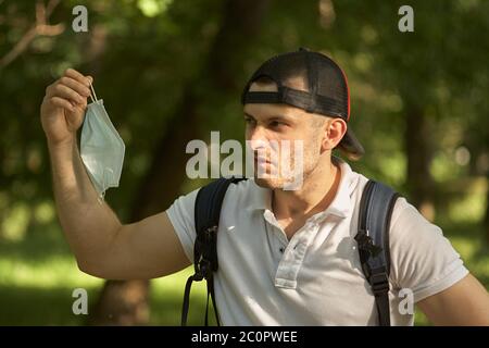 The guy takes off the mask from his face. Walk in the park Stock Photo ...
