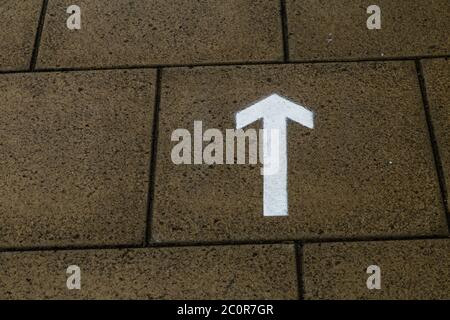 Directional arrow on pavement Stock Photo - Alamy