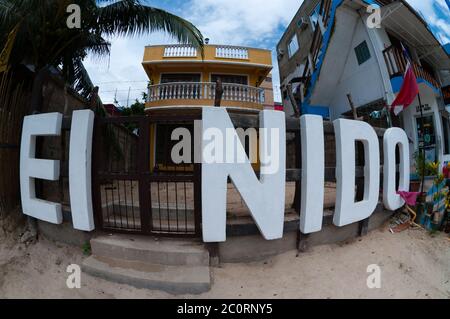El Nido sign at the beach in front of houses Stock Photo - Alamy