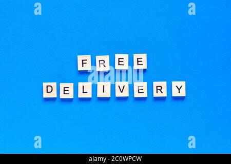 free shipping lettering in wooden letters on a blue background, top ...