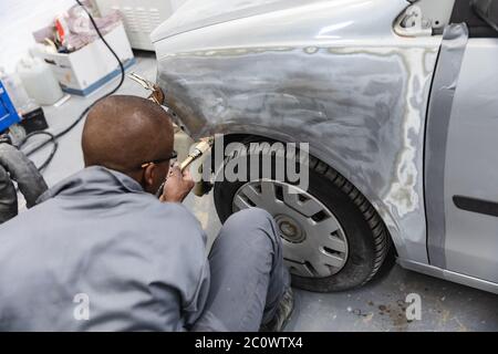 African-American car mechanic on white background Stock Photo - Alamy