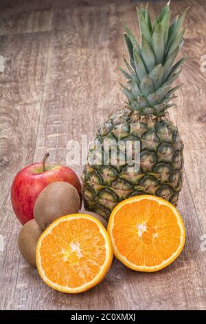 Pineapple and apple on wood table, outdoor Stock Photo - Alamy