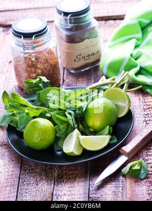 Caipirinha Ingredients with mortar and pestle and fresh lime. Aside an ...