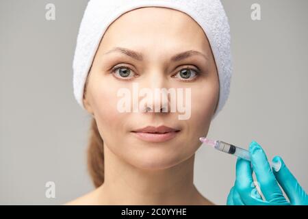 Platelet-rich plasma facial treatment. Close-up of mature woman ...