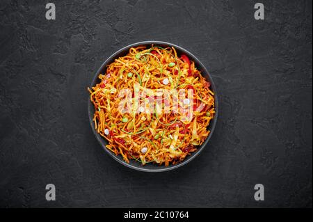 Chinese Bhel in black bowl on dark slate table top. Chinese Bhel is ...