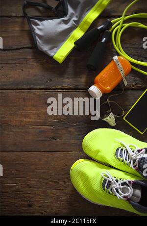 Sneakers with skipping rope and tape on green background Stock Photo ...