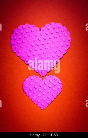 Small girl holding hearts on sticks. Cute girl with red hearts. Child ...