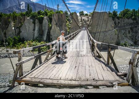 woman crossing an unstable wooden bridge Stock Photo - Alamy