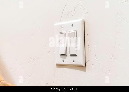 Rocker light switch with multiple flat broad lever mounted on the ...