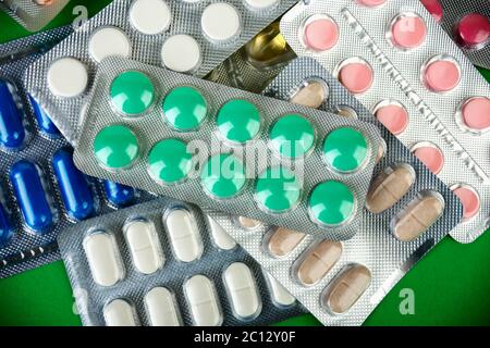 group of multi-colored pharmaceutical medication and medicine pills in ...