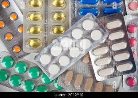 group of multi-colored pharmaceutical medication and medicine pills in ...
