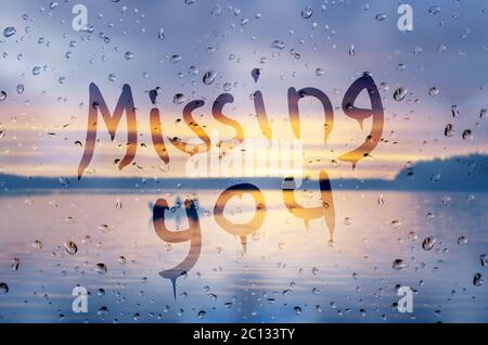 Rain on glass with Missing You text Stock Photo - Alamy