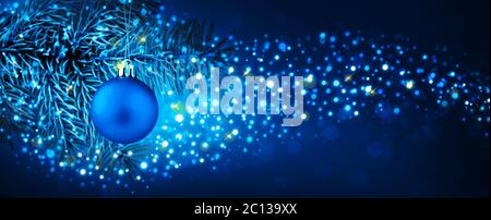 Christmas ball hanging on fir tree against dark background with blurred ...