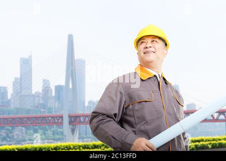 old asian man engineer with blueprint and bridge Stock Photo - Alamy