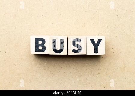 Letter block in word busy on white wood background Stock Photo - Alamy