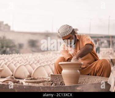Indian man doing the traditional morning ablution at the ghats ...