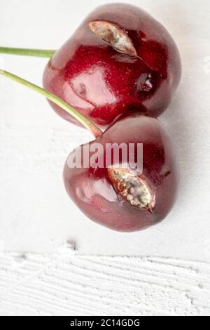 closeup of mouldy cherry fruits on a white background with copy space ...