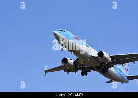 A TUI aeroplane in the sky at Bristol International Airport, UK - With ...