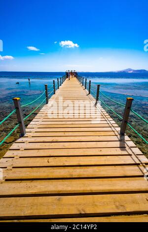 Hard modern wooden bridge at popular tourist port Stock Photo - Alamy
