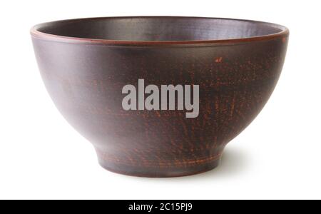 empty rustic terracotta kitchen bowl and spoon on a wooden tabletop ...