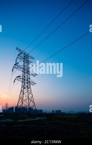 Pylons in blue sky at sunrise Stock Photo - Alamy