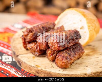 Traditional romanian barbecue with minced pork meat rolls (mici or ...
