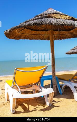 Tropical beach with deckchair Stock Photo - Alamy