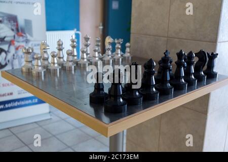 Chess board with metal figures on it indoors on the table at daytime ...