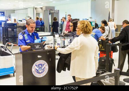 Travelers line up at a security checkpoint area in Terminal 3 at the O ...