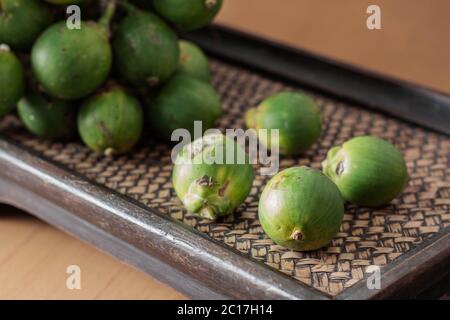 Betel nut on the old wooden tray Stock Photo - Alamy
