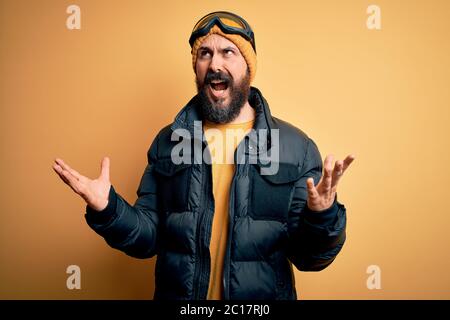 Handsome skier bald man with beard skiing wearing snow sportswear and ...