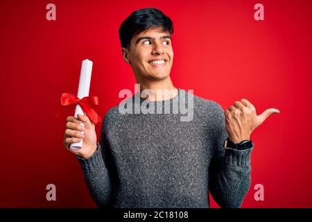 Happy graduated student with diploma and thumb up isolated on white ...