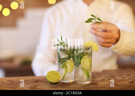 Bartender making two mojito cocktails Stock Photo - Alamy