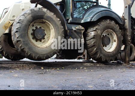 Tractor strong outrigger stabilizing legs extended to stabilize and ...