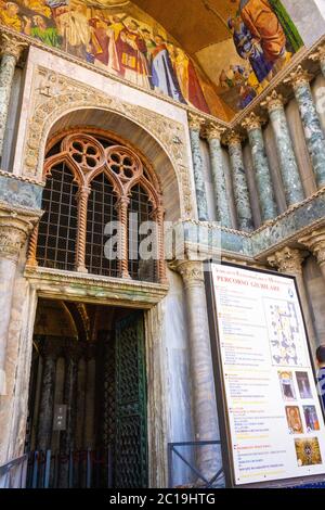 One of the five round-arched portals, enveloped by polychrome marble ...