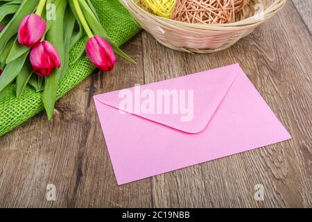 Envelope with letter on pink wooden background top view Stock Photo - Alamy