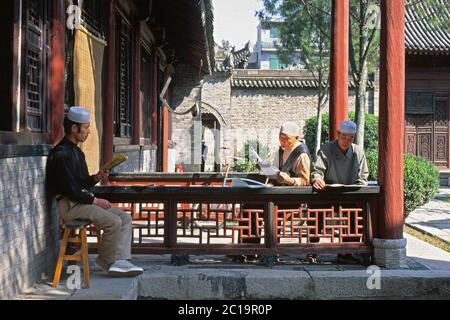 Hui Muslim men studying the Quran at madrassa classroom in Dongguan ...