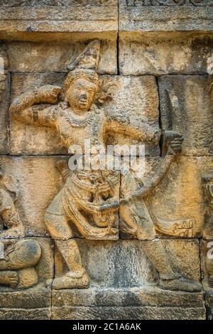 Figure of a female archer carved on the wall in the Borobudur temple ...