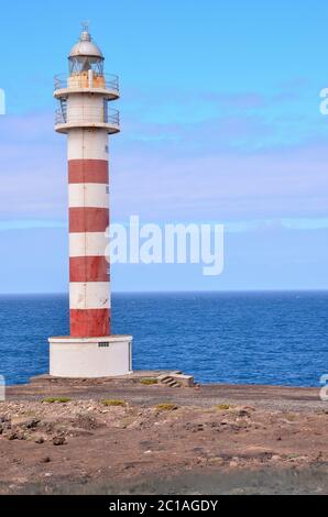 High Lighthouse near the Coast Stock Photo - Alamy