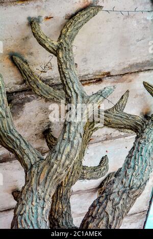 Clumsy artificial tree supports roof like decorative pillar ...